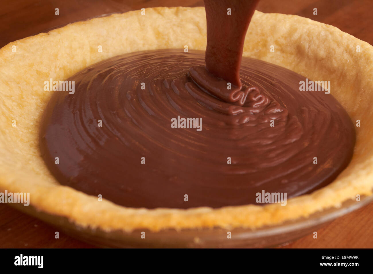 Pouring Chocolate Cream filling into pie shell Stock Photo - Alamy