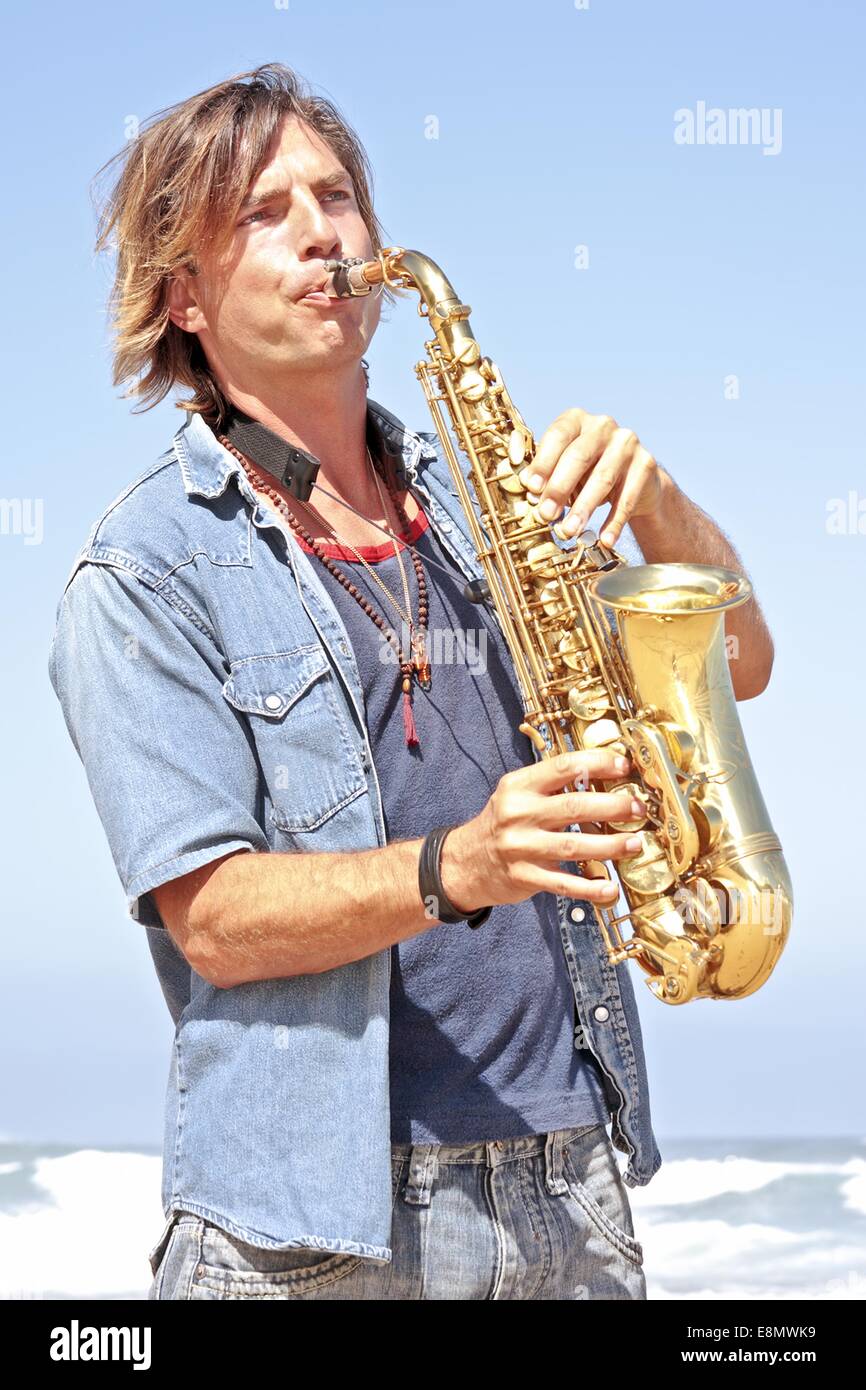 Professional saxophone player at the beach Stock Photo - Alamy