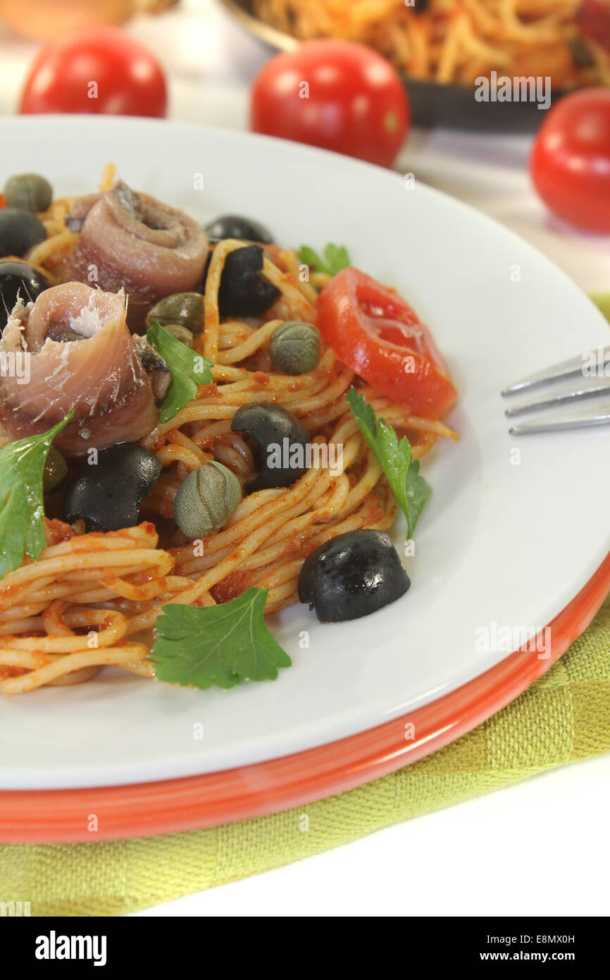 Spaghetti alla puttanesca with olives, capers and anchovies Stock Photo ...