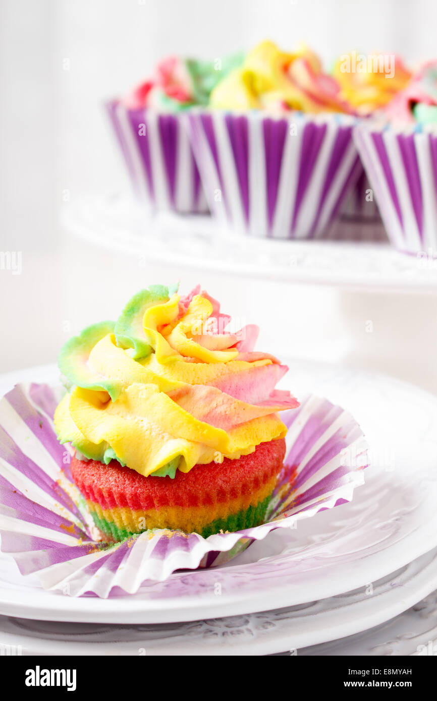 Rainbow colored muffin ready to eat Stock Photo - Alamy