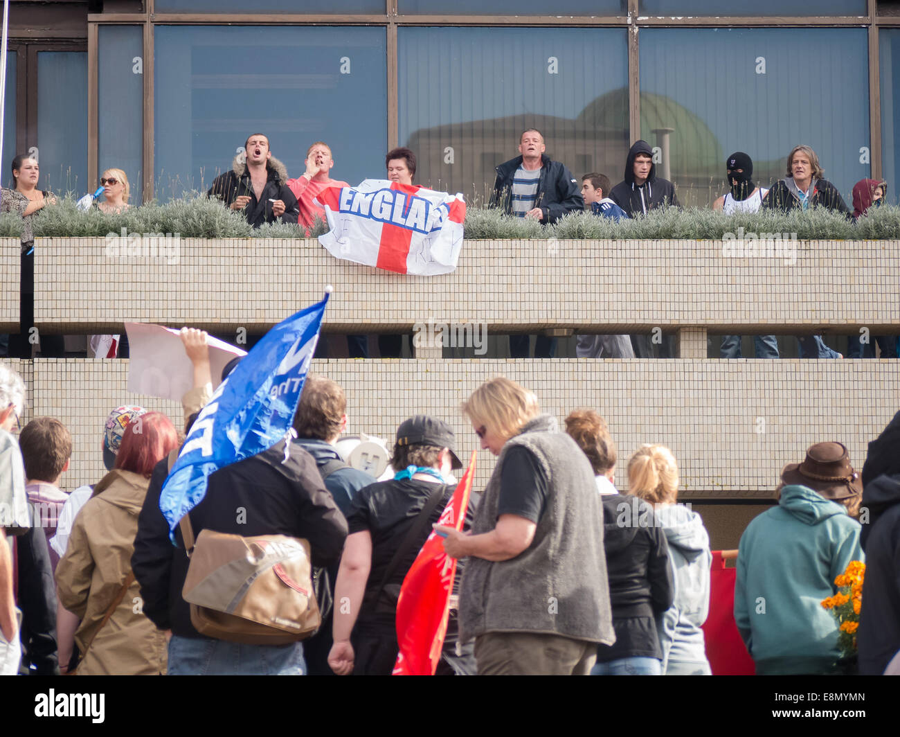Members of the English Defence League stand above anti fascist ...