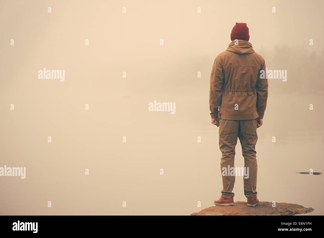 Young Man standing alone outdoor with foggy scandinavian nature on ...