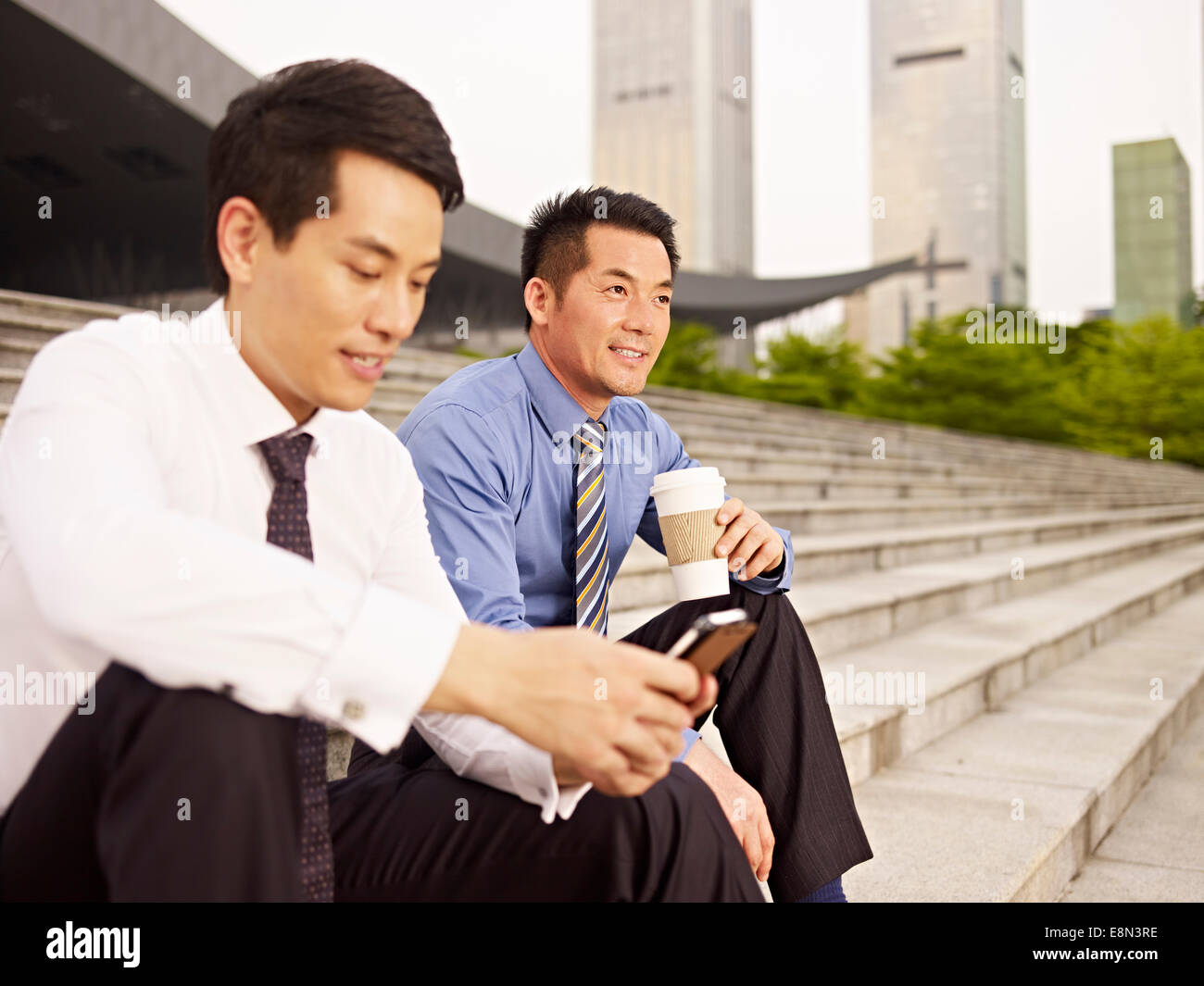 Colleagues enjoying coffee break sitting hi-res stock photography and ...
