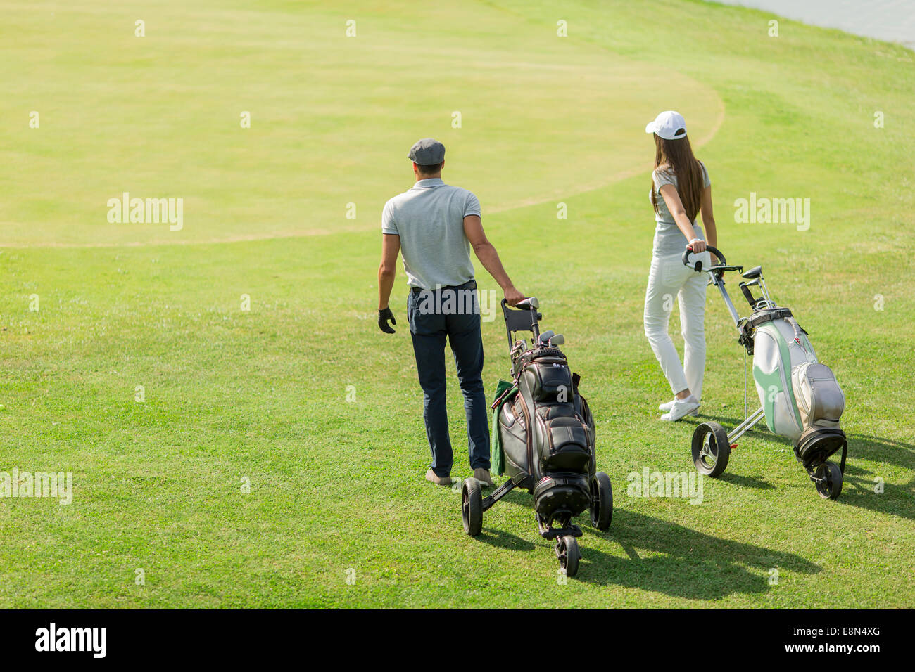 Young couple playing golf Stock Photo - Alamy