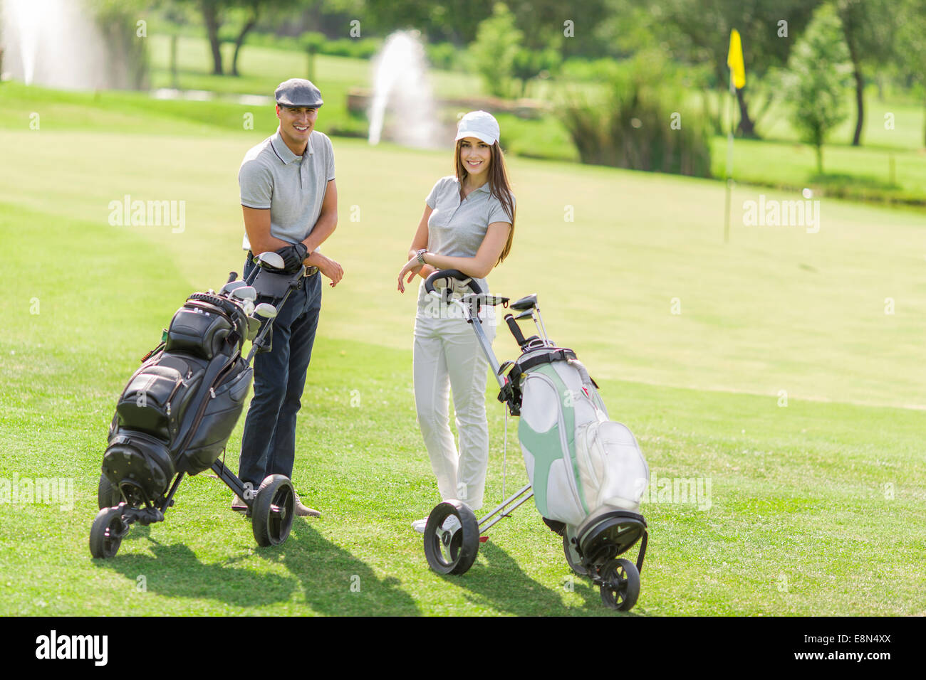 Young couple playing golf Stock Photo - Alamy