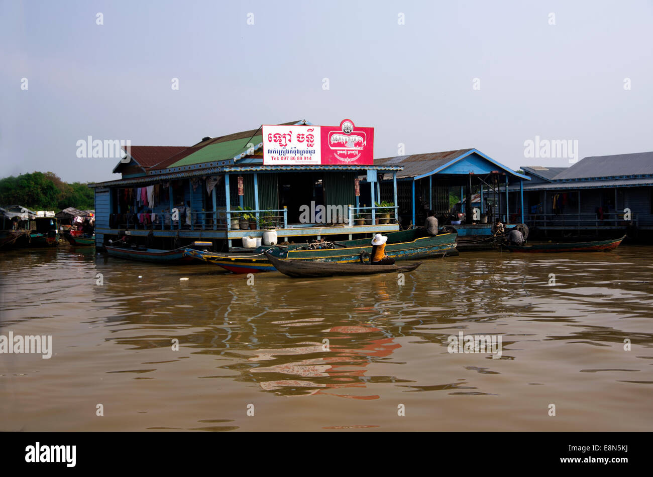Tonle Sap Lake, floating grocery store, woman pushes her small ...