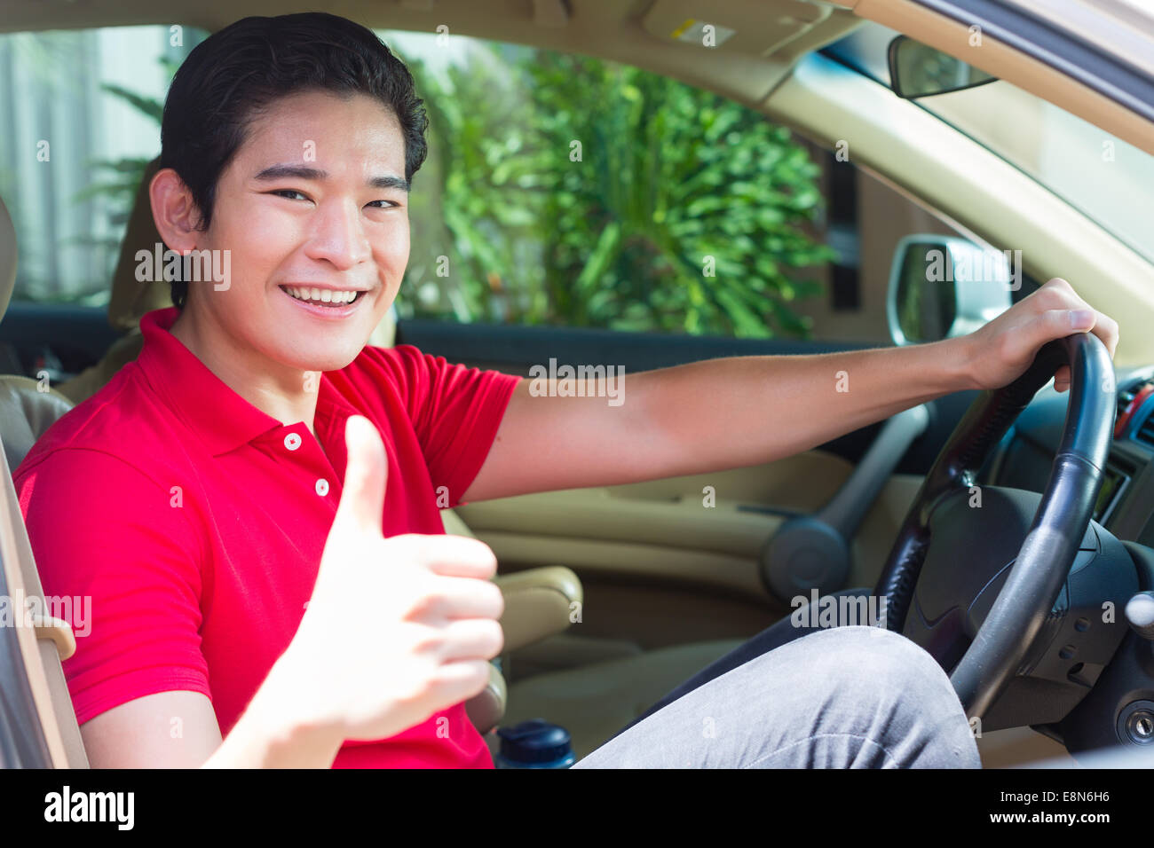 Asian man driving new car Stock Photo - Alamy