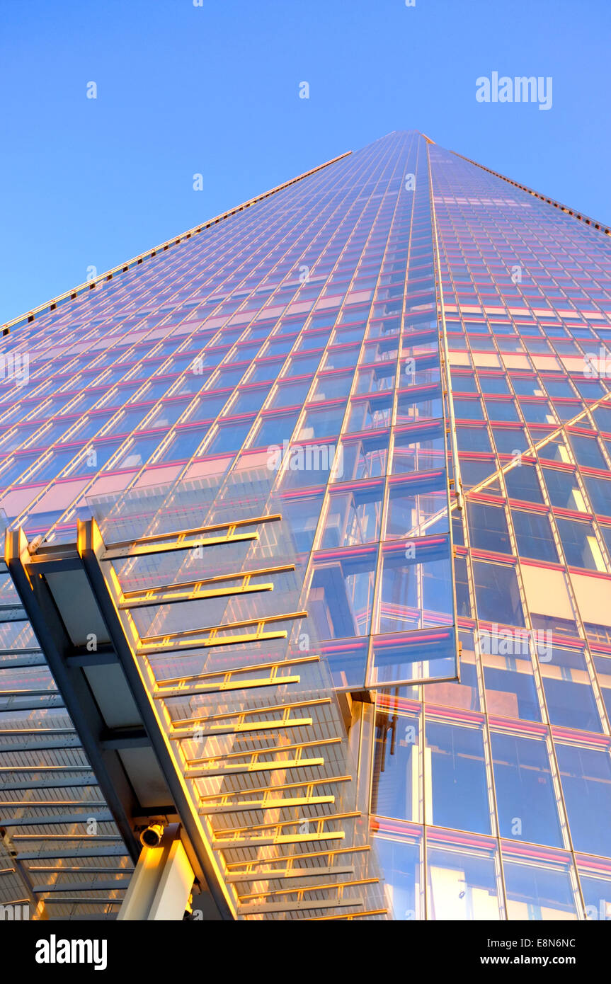 The Shard building in London reflects the pink sunset golden hour glow ...