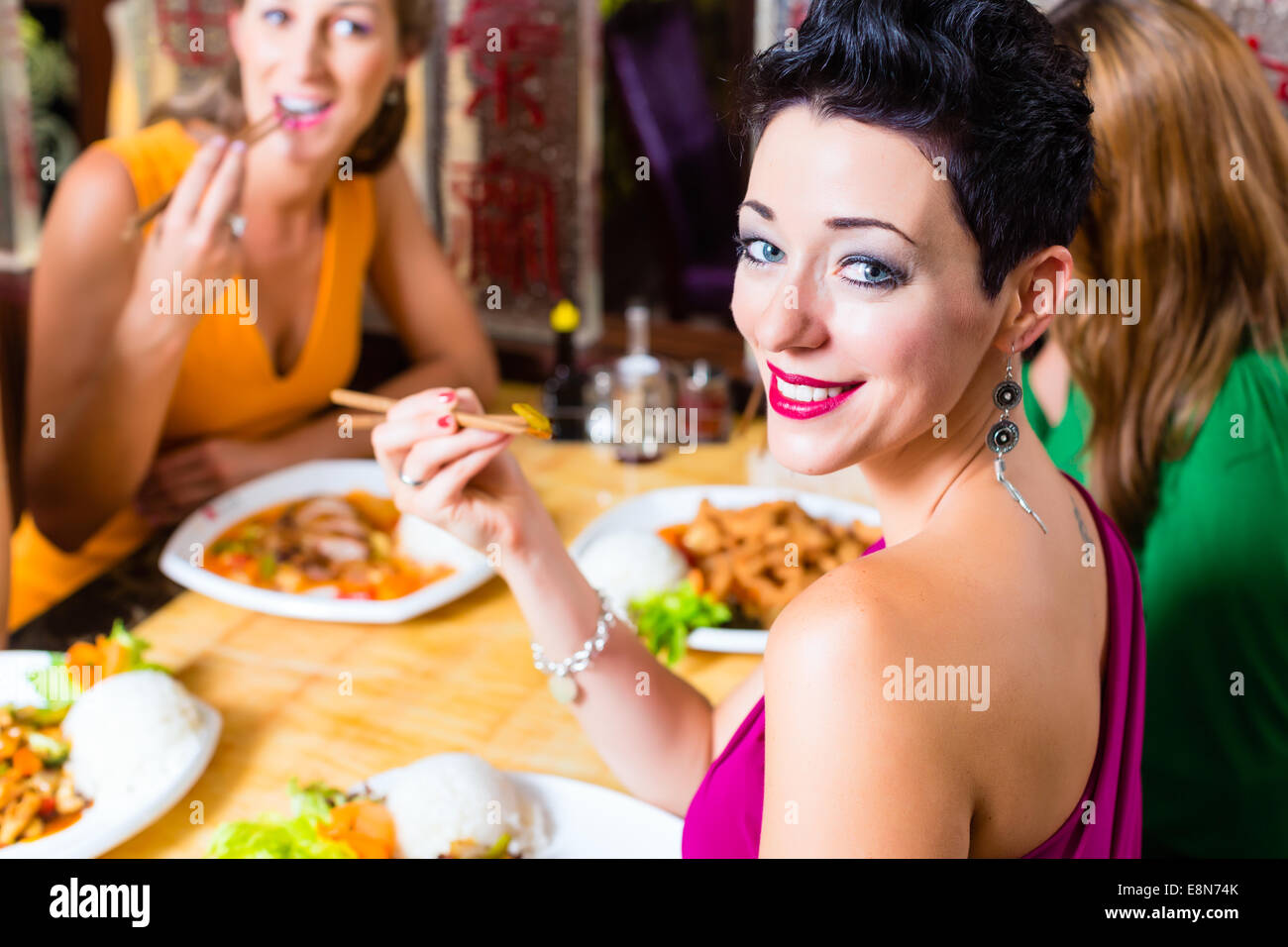 Young people eating in Asia restaurant Stock Photo - Alamy