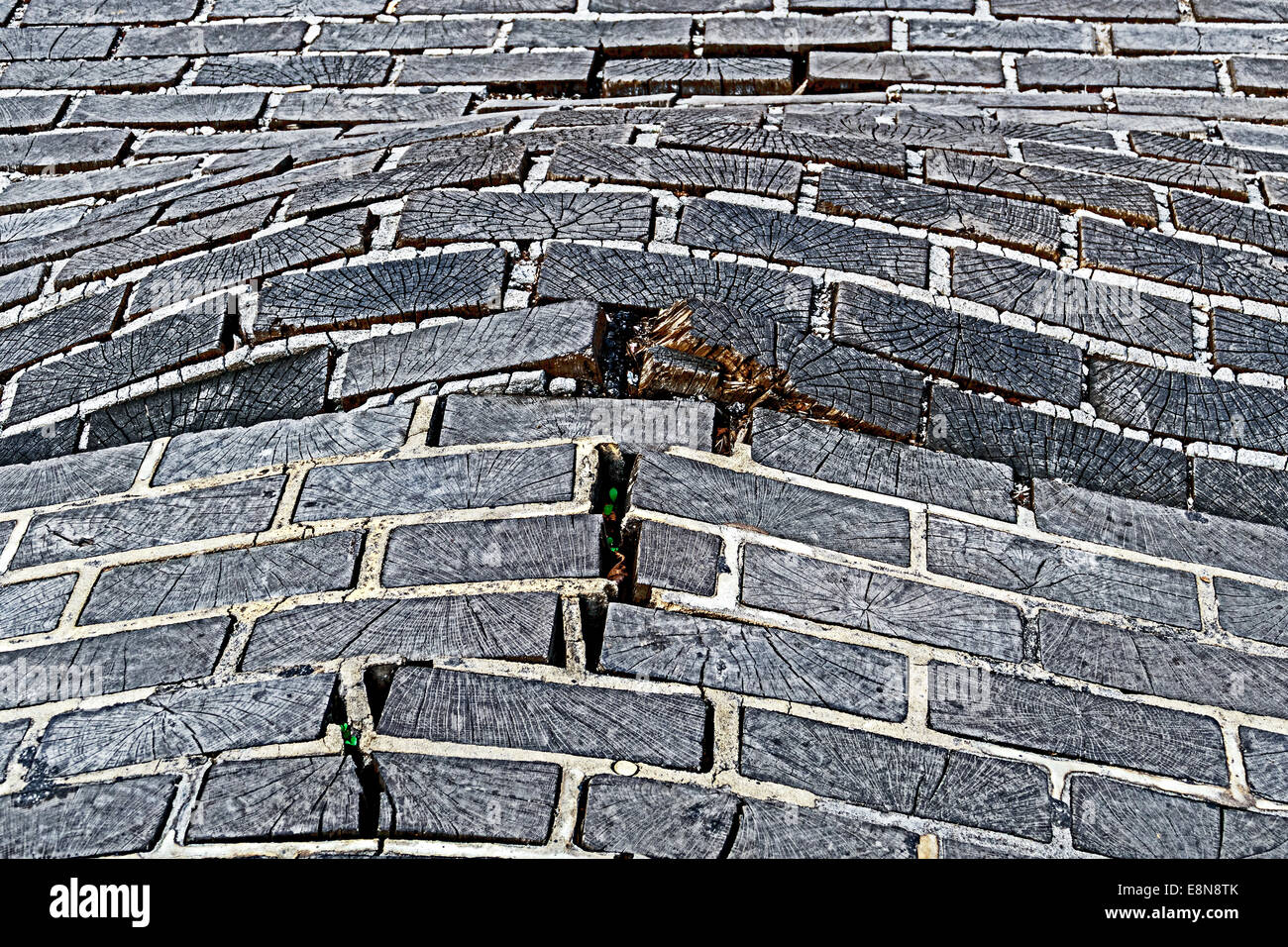 Paving from wooden square, bloated and damaged Stock Photo - Alamy