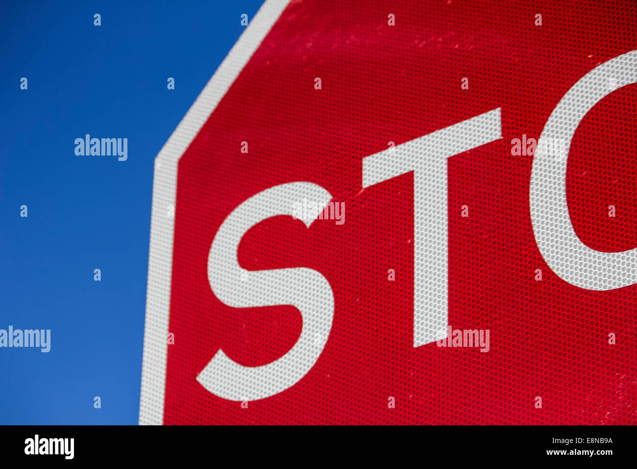 Red and white stop sign with a vibrant and cloudless blue sky behind ...