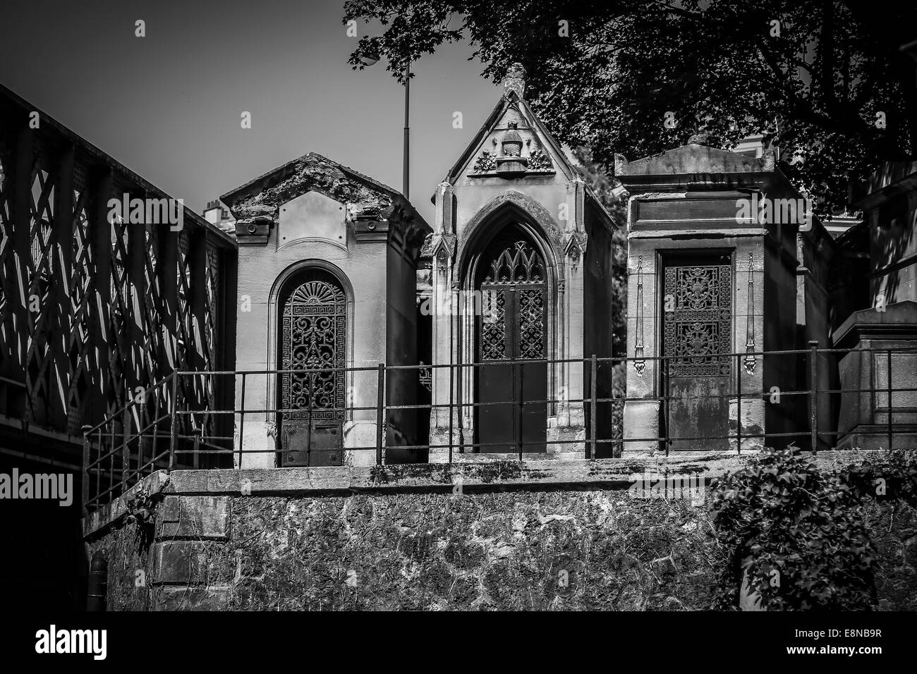 Side by side stands three stone mausoleums in an old cemetery Stock ...