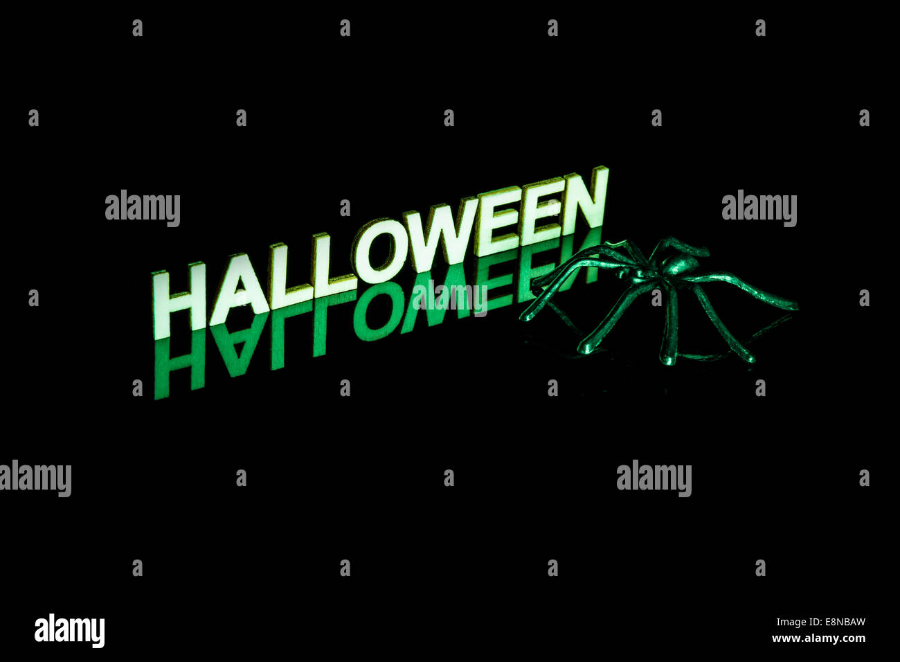 The word halloween in wooden letters reflected on a black background ...