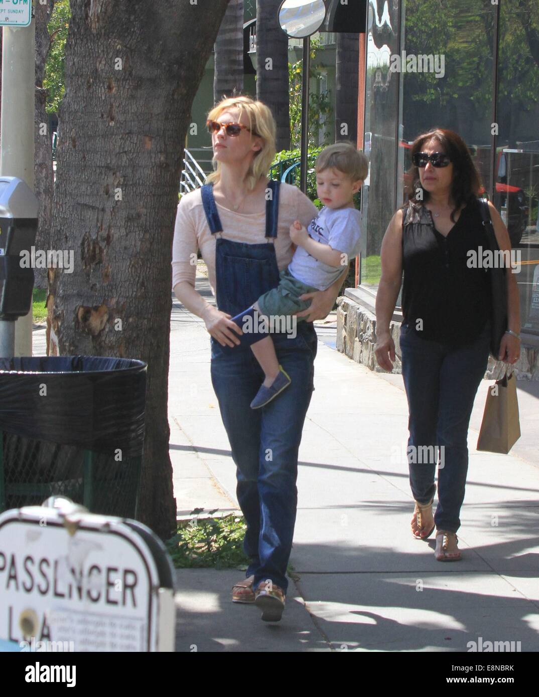 January Jones, out and about wearing denim overalls and tortoiseshell ...