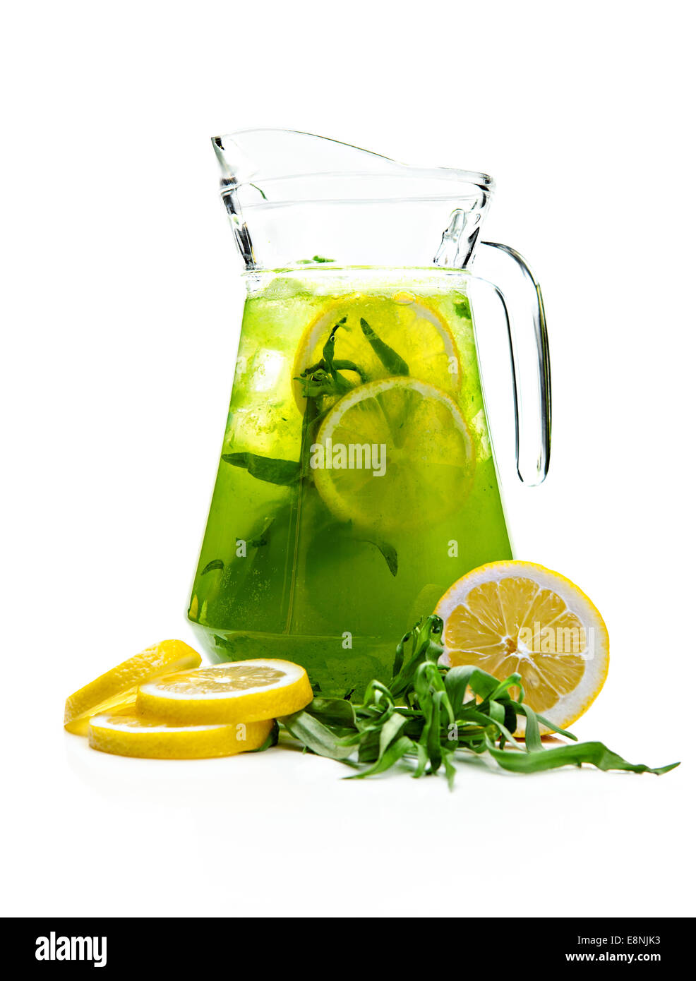 pitcher with a refreshing drink (tarhun) with lemon slices on white ...