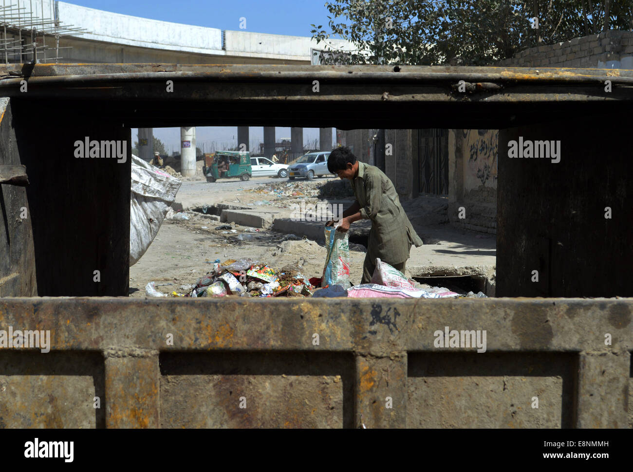 Quetta. 12th Oct, 2014. A Pakistani boy collects usable things from the ...