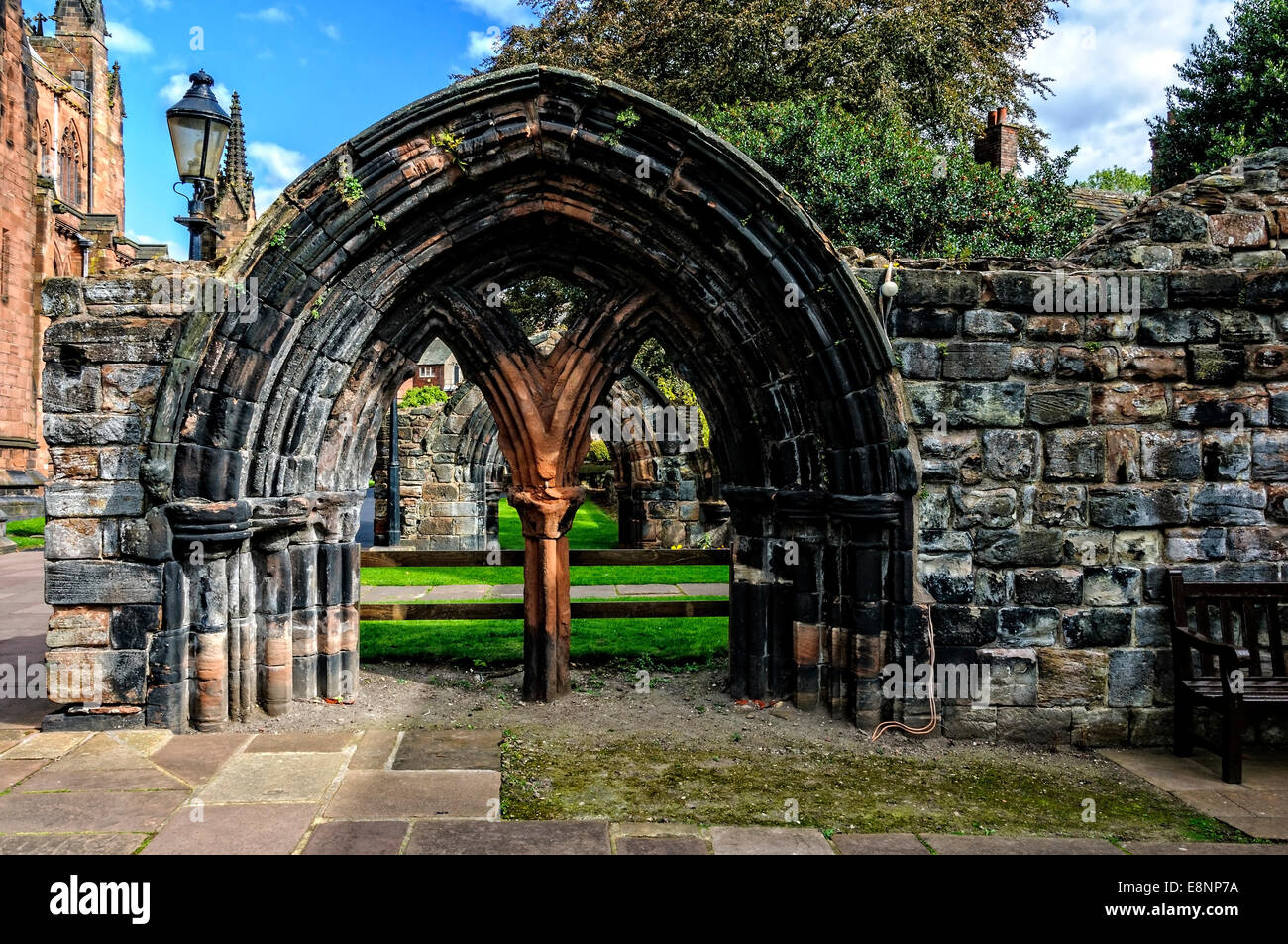 The ruins of a red sandstone pointed-arched doorway with trumeau and ...