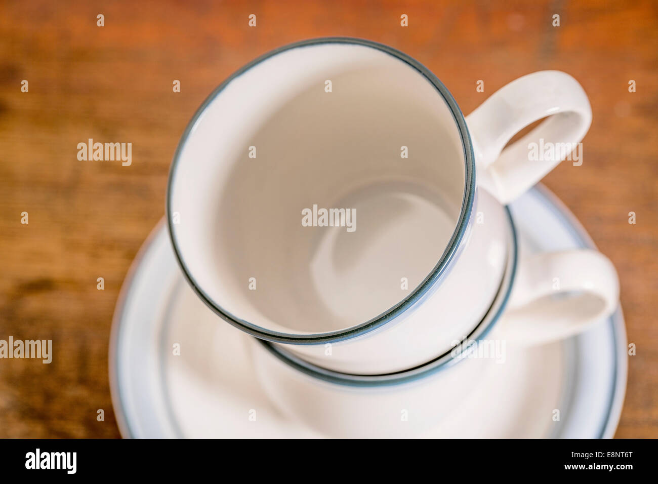 two empty stacked coffee cups on a grunge wood table, shallow depth of ...