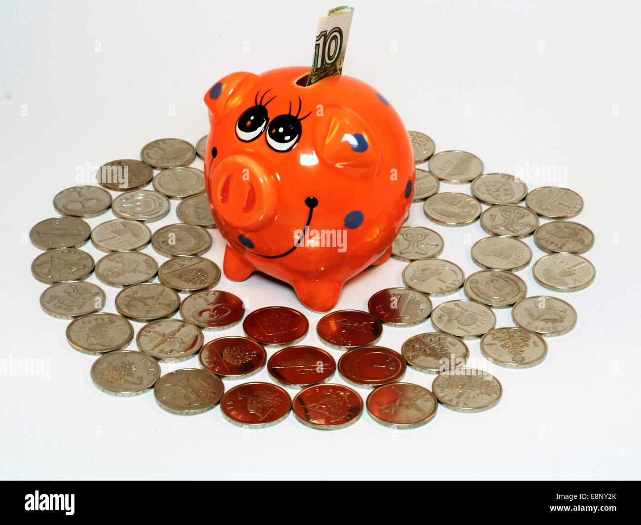 Bunch of Latvian lat coins and piggy bank on white background Stock ...