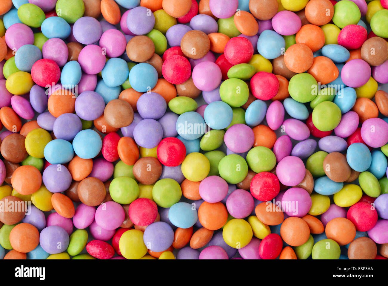 Sweet round multicolor candies spreading on background Stock Photo - Alamy