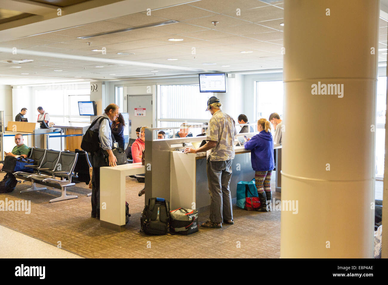 People using electrical outlets to power their electronic devices while ...