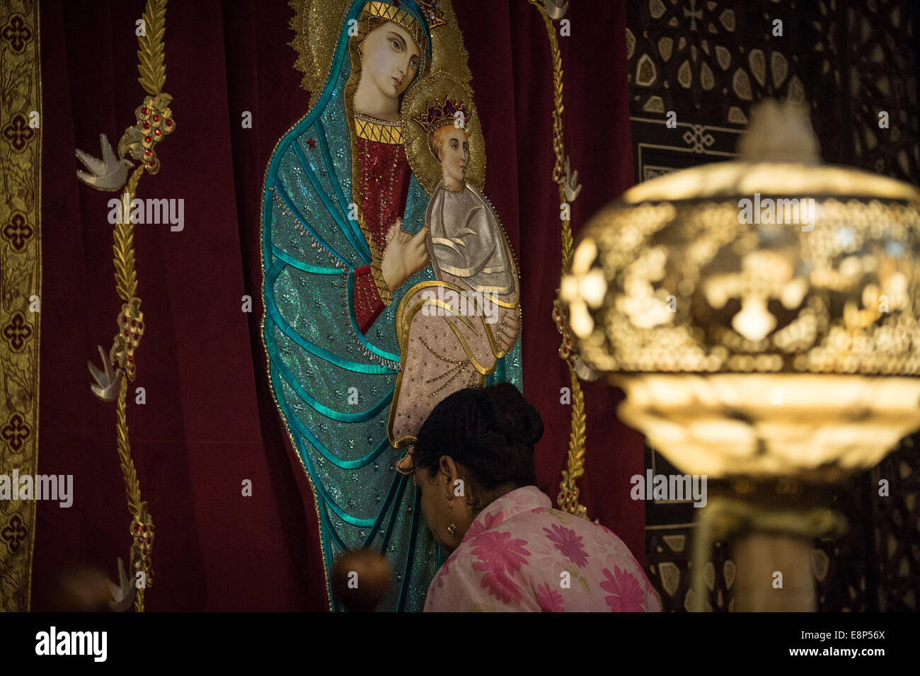 Cairo, Egypt. 11th Oct, 2014. A Coptic woman prays at the hanging ...