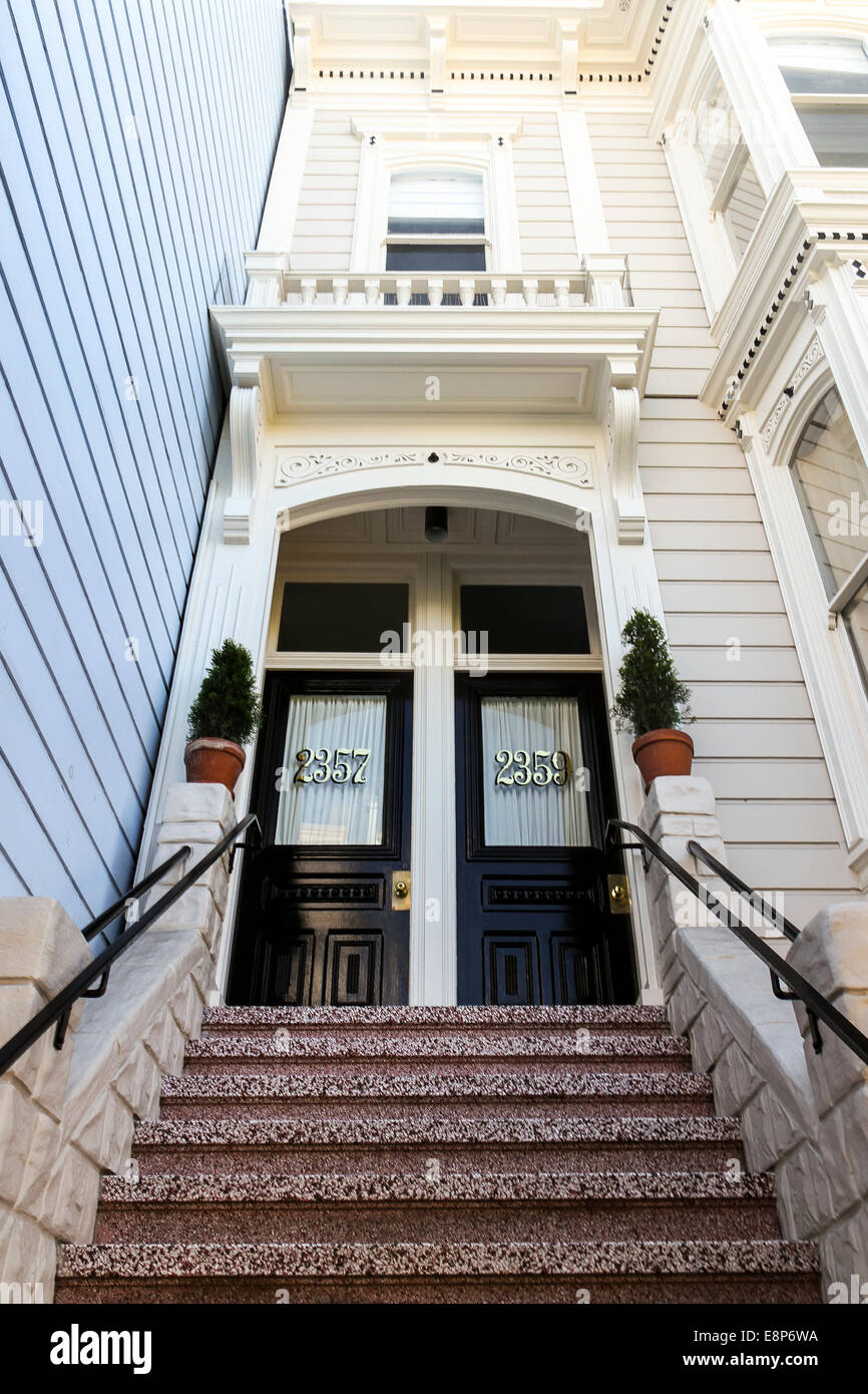 Looking up front steps towards entrances to a two-family building in ...