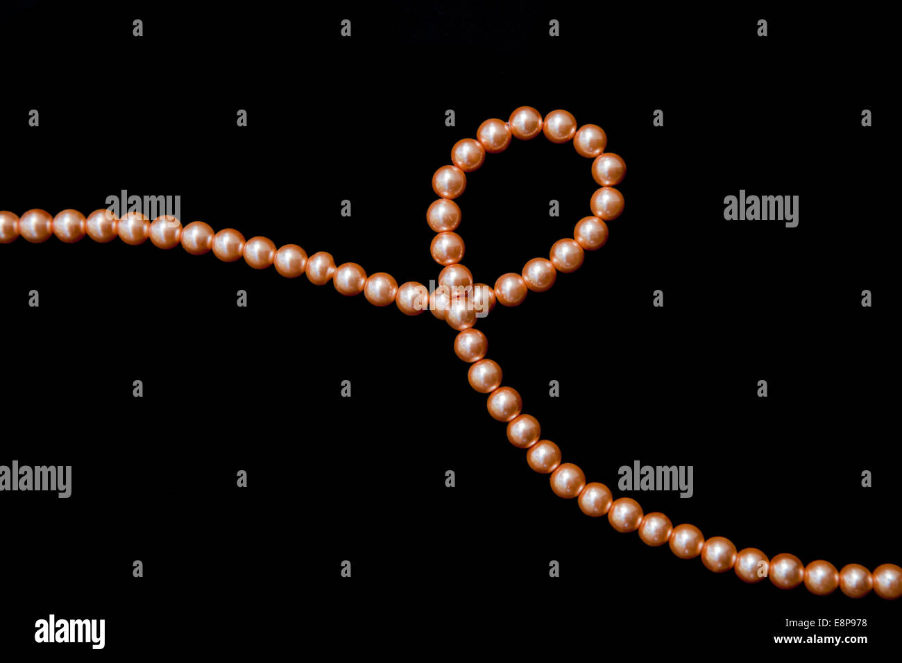 Decoration thread of orange imitation pearls with single loop over ...
