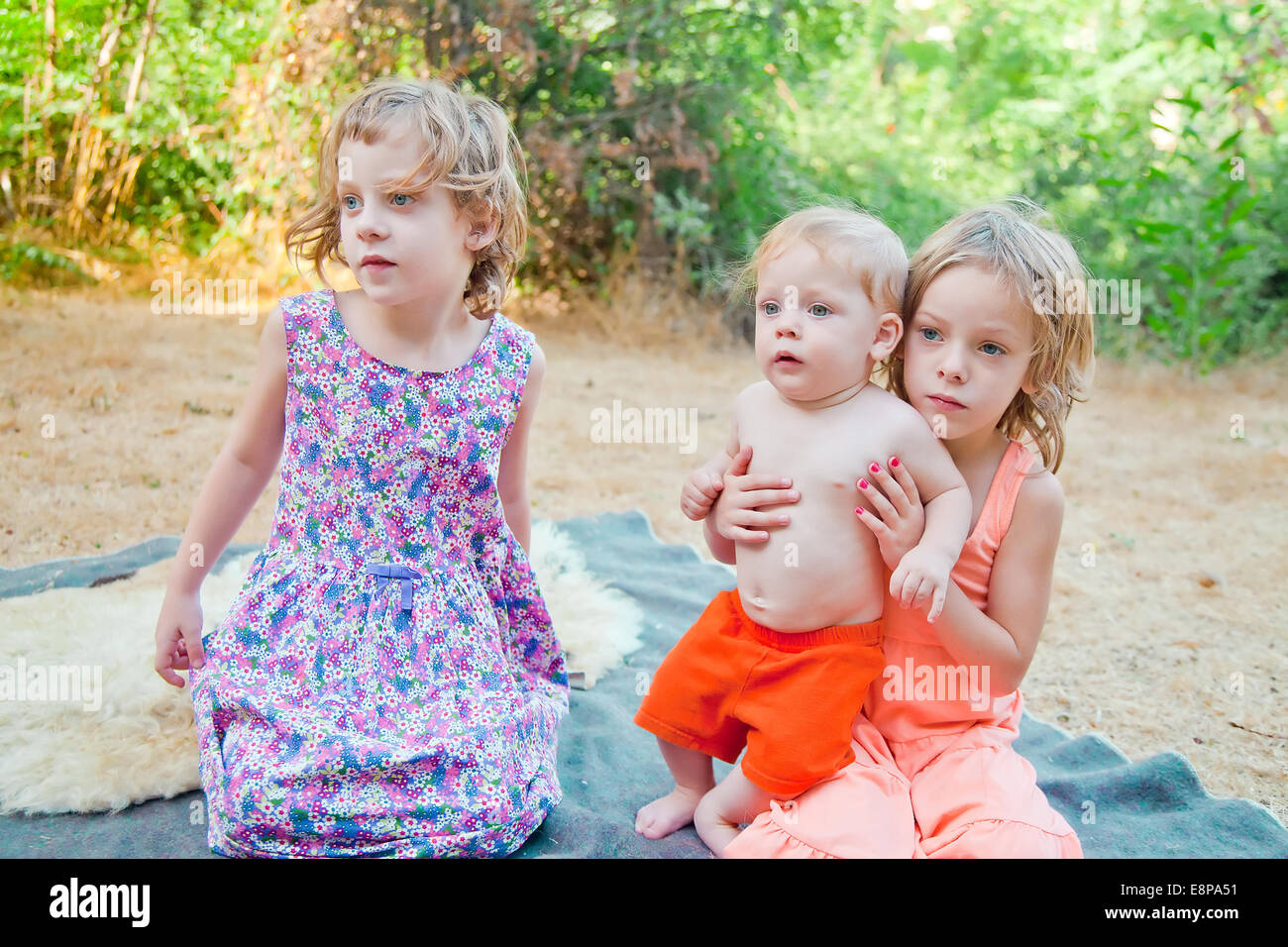 Three little children stare with startled expressions Stock Photo - Alamy