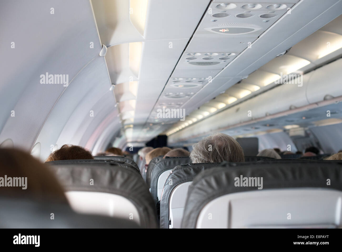 Interior inside of the plane with passengers Stock Photo - Alamy