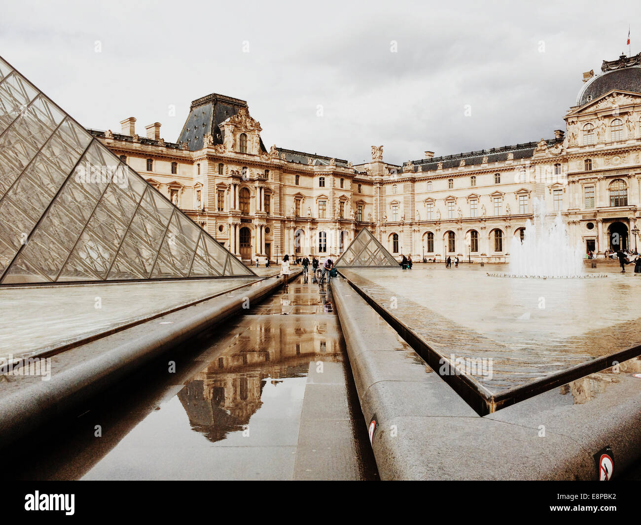 Facade of Louvre Museum seen from Cour Napoleon, with fountain and part ...