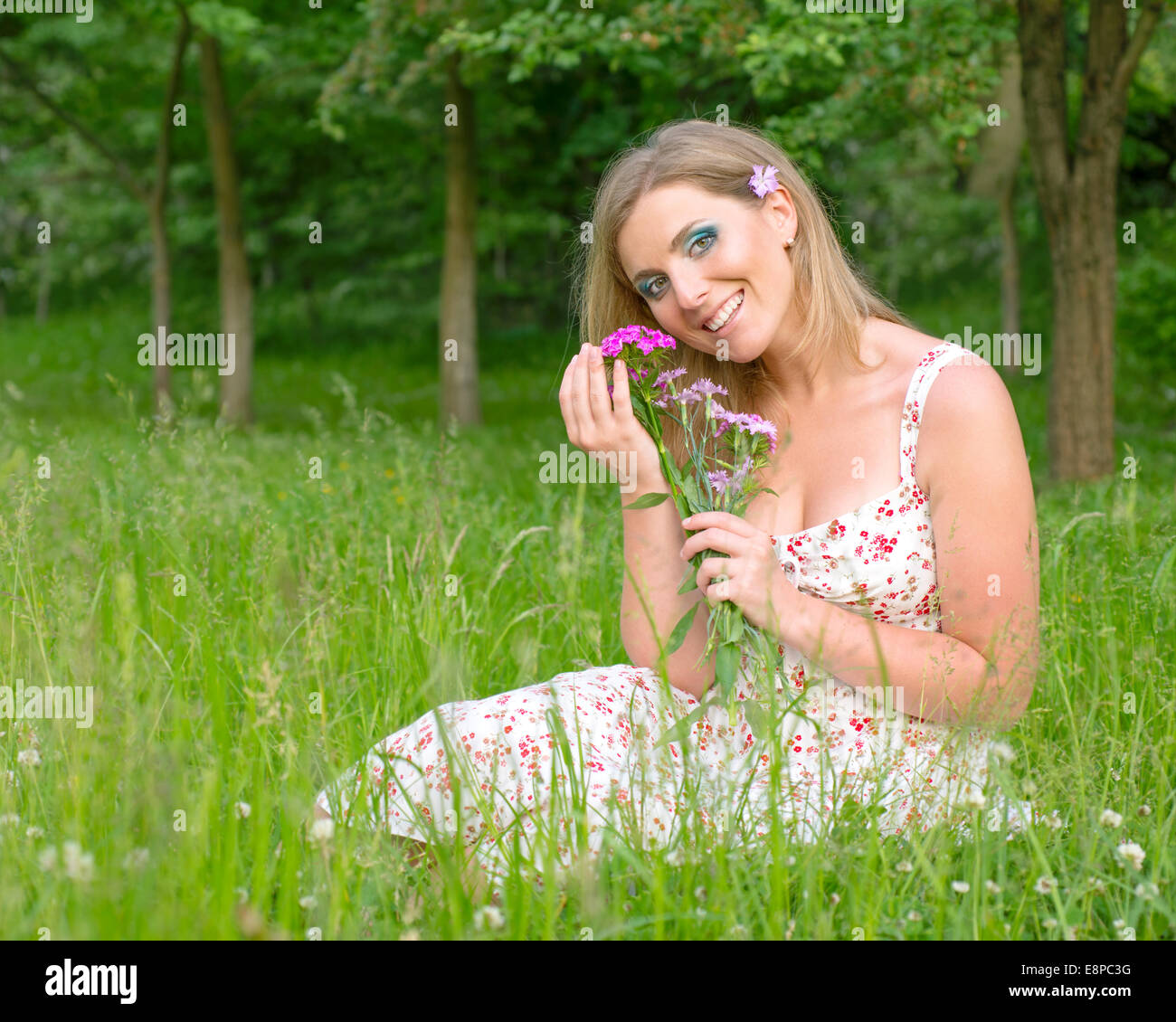 Woman with flowers in nature Stock Photo - Alamy