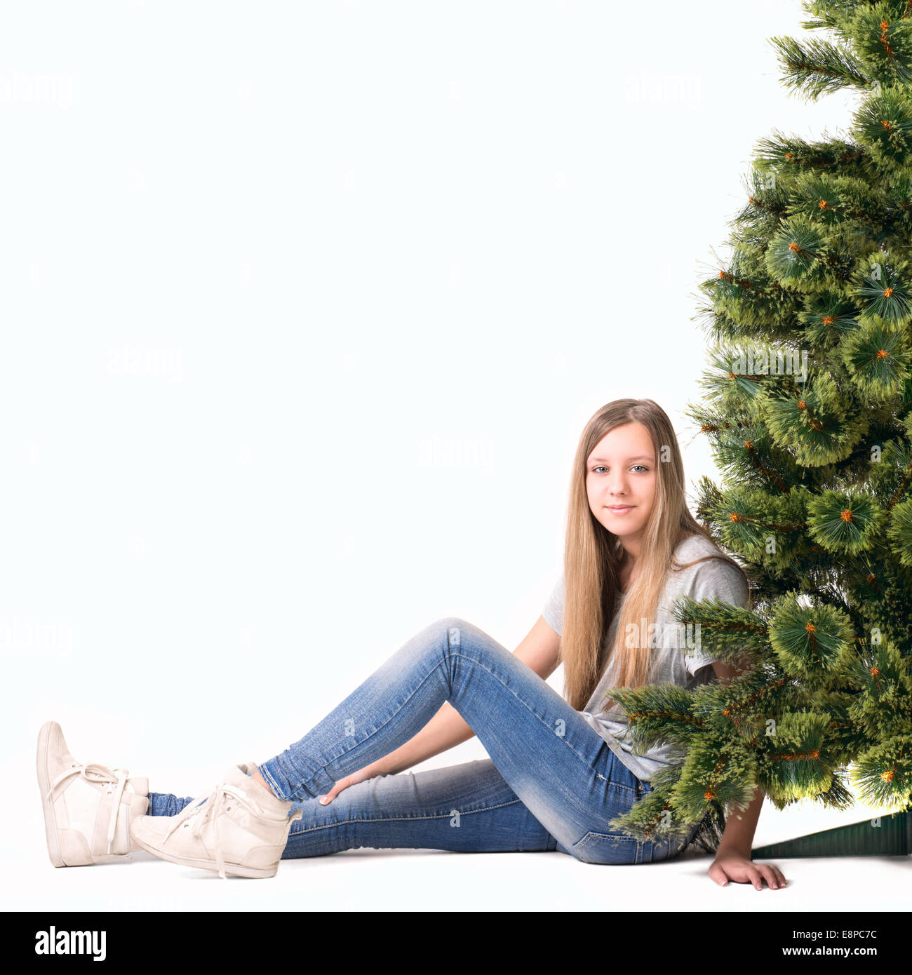 Girl sitting under the tree Stock Photo - Alamy