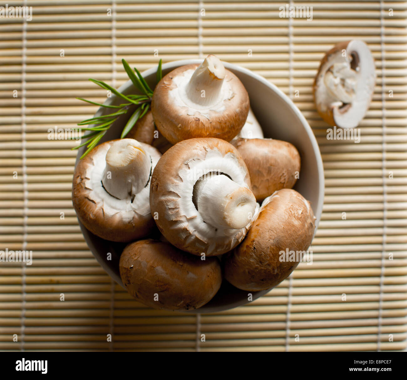 Brown champignon mushroom and rosemary leaves Stock Photo - Alamy