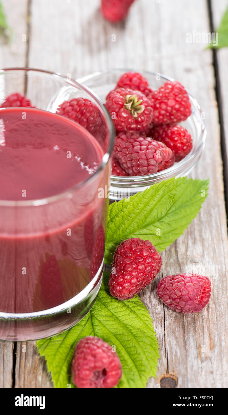 Portion of fresh made Raspberry Juice with some fruits Stock Photo - Alamy