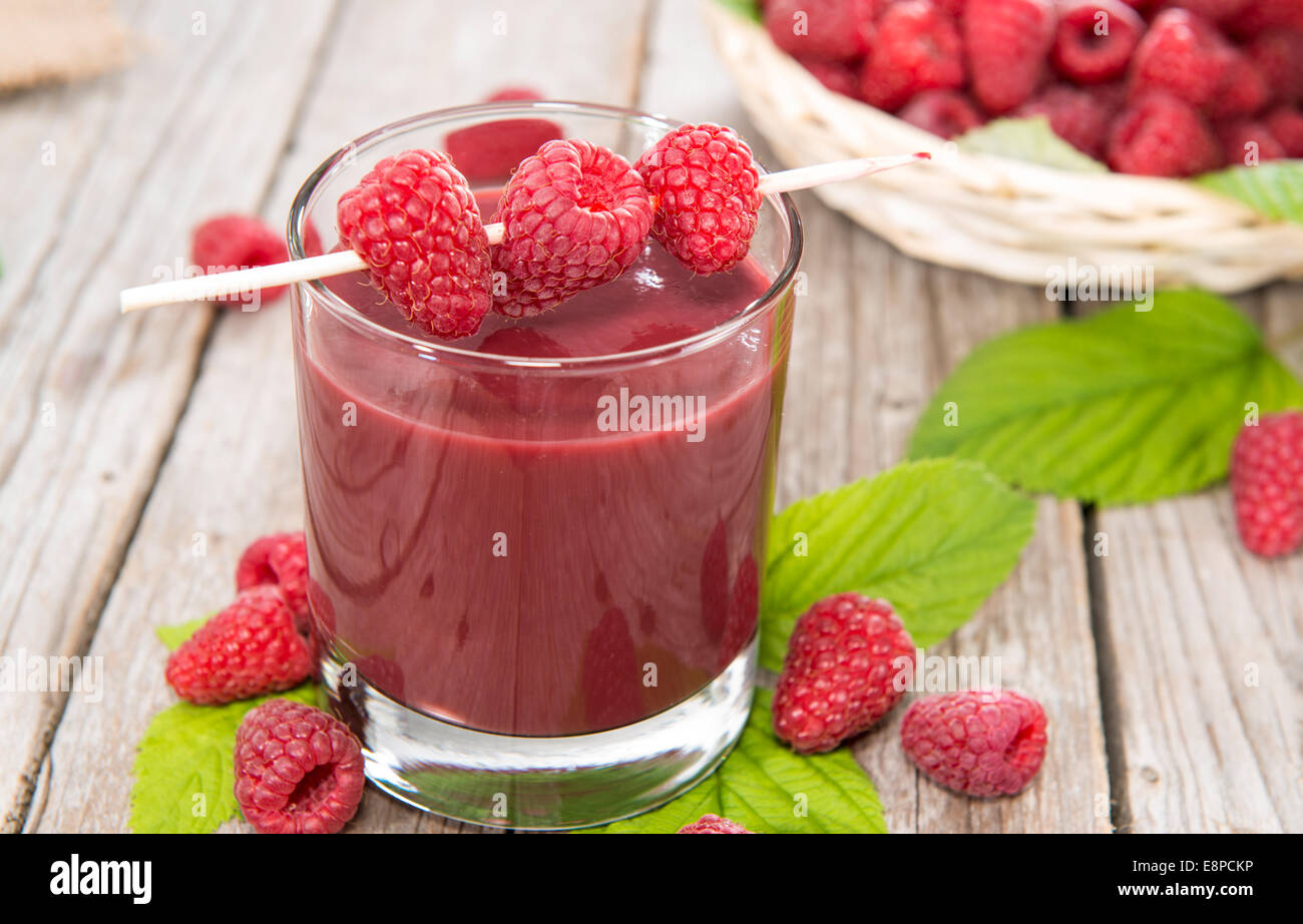 Glass with homemade Raspberry Juice and some fresh fruits on wooden ...