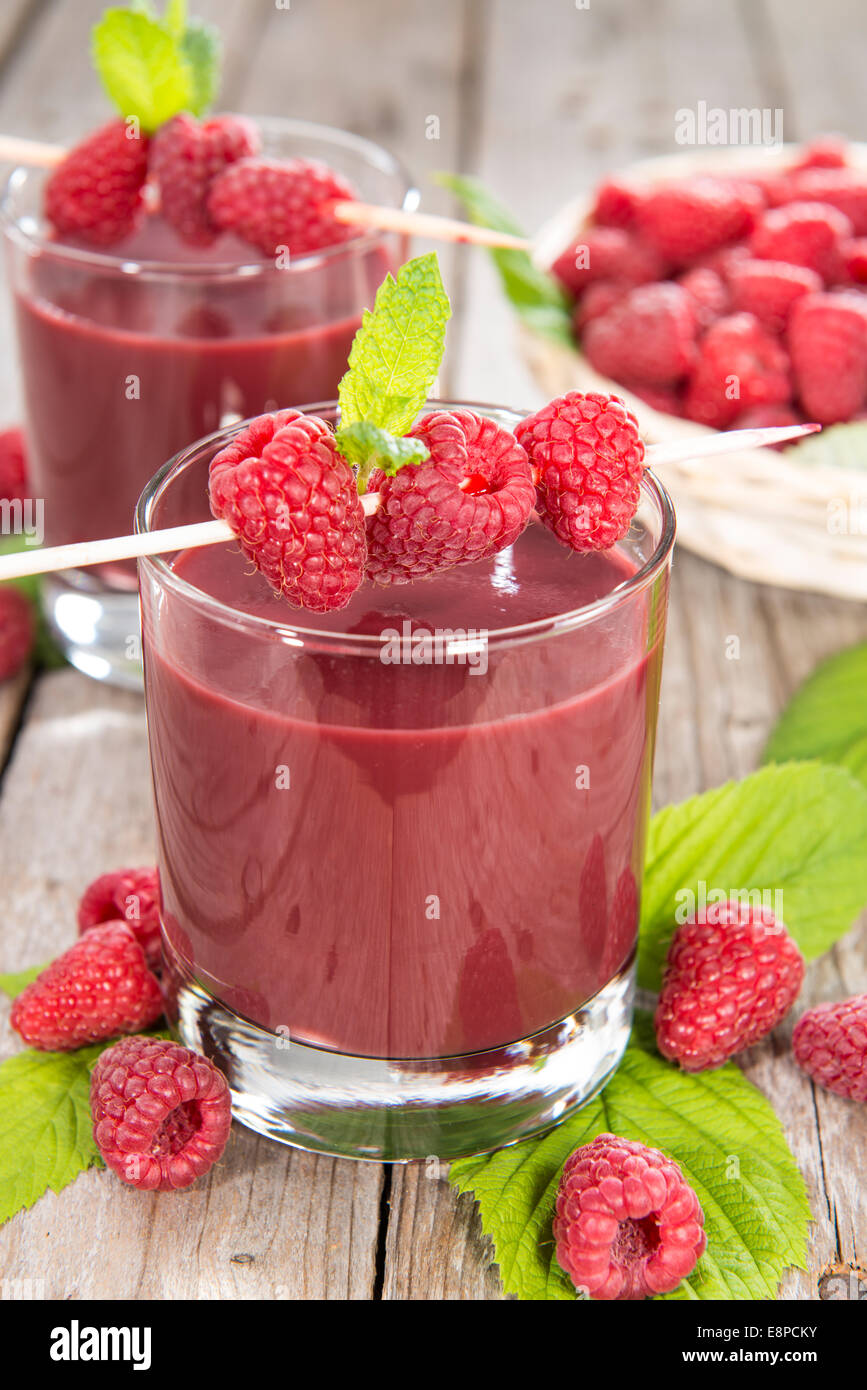 Portion of fresh made Raspberry Juice with some fruits Stock Photo - Alamy