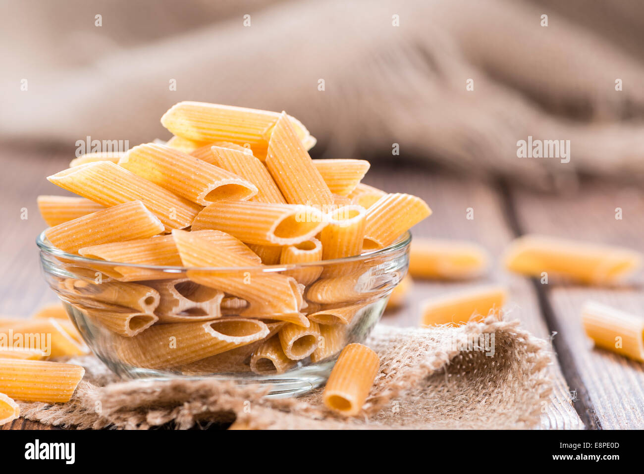 Wholemeal Penne as close-up shot on vintage wooden background Stock ...
