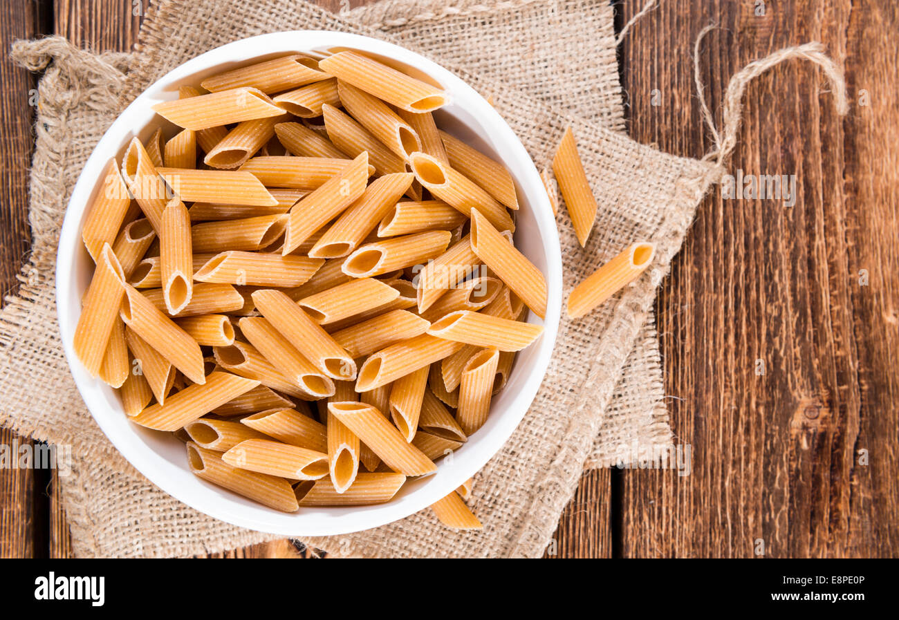 Wholemeal Penne as close-up shot on vintage wooden background Stock ...