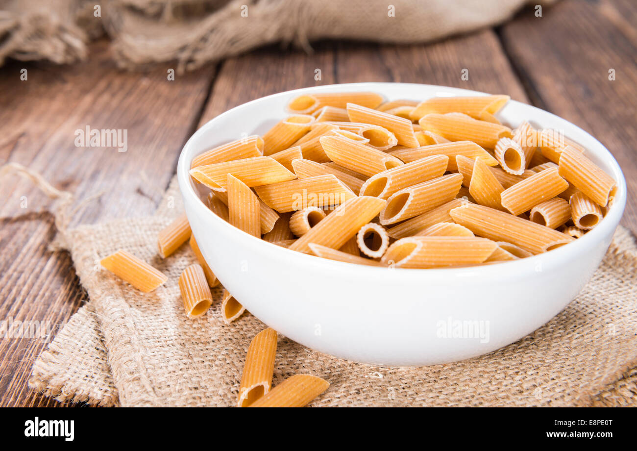 Portion of wholemeal Penne on an old vintage table Stock Photo - Alamy