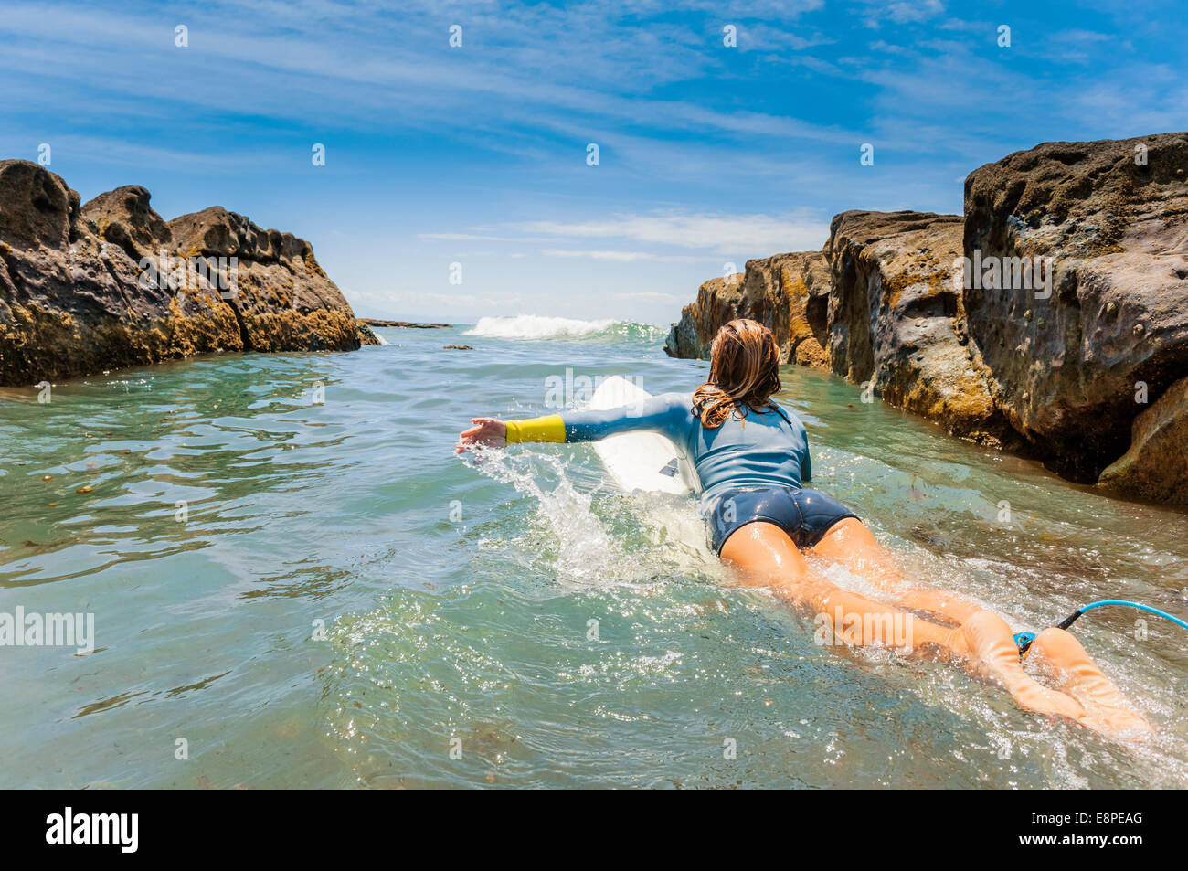 Woman surfing out into the sea Stock Photo - Alamy