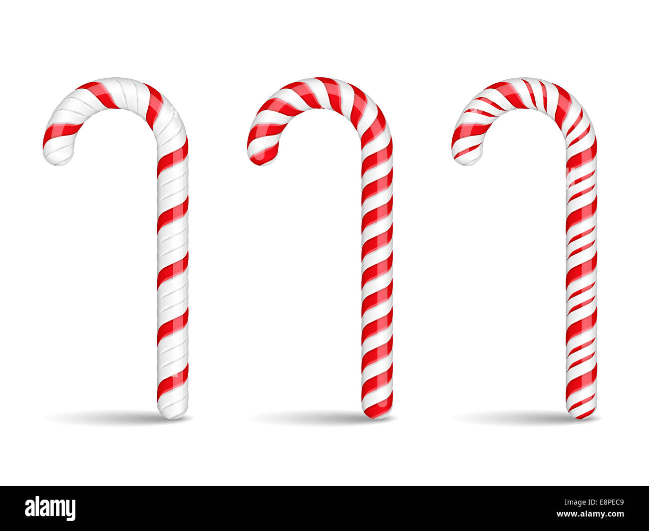 Three candy canes on white background Stock Photo - Alamy