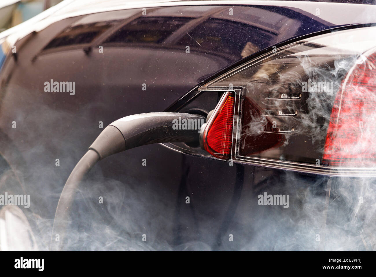 Electric car vs pollution Stock Photo - Alamy