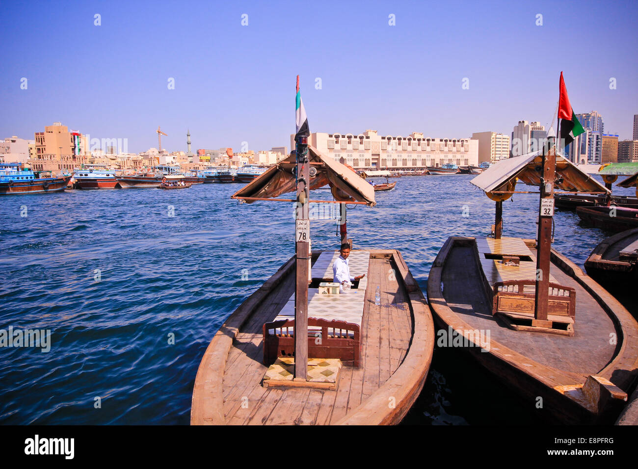 Traditional Abra water ferries crossing The Creek at Deira in Dubai ...