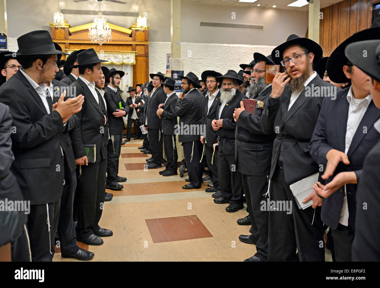 Crowd of orthodox religious Jewish men prior to afternoon services at a ...