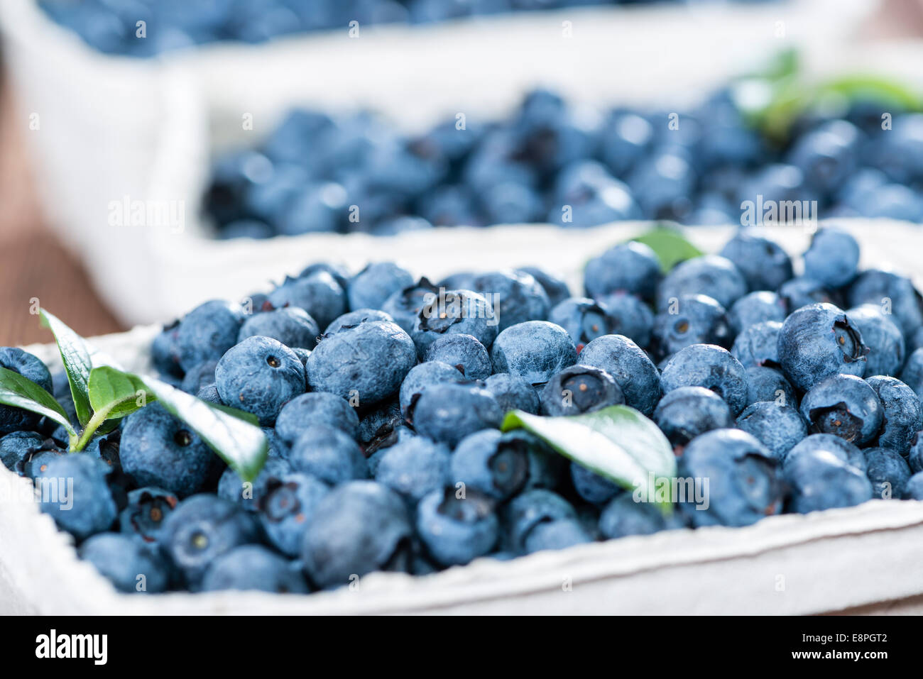 Portion of fresh harvested Blueberries on vintage wooden background ...