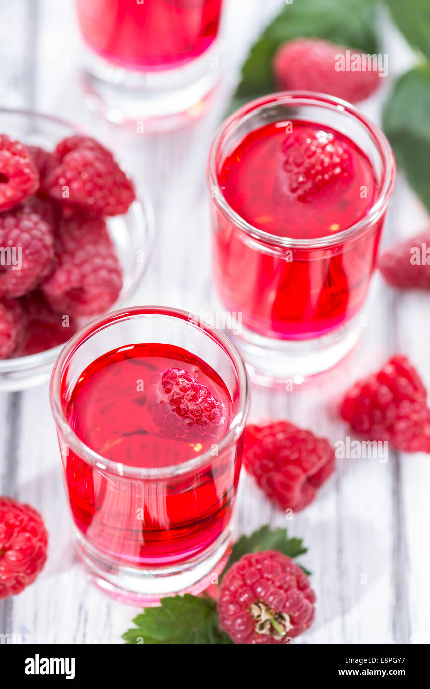 Homemade Raspberry Liqueur in a glass with some fresh fruits Stock ...