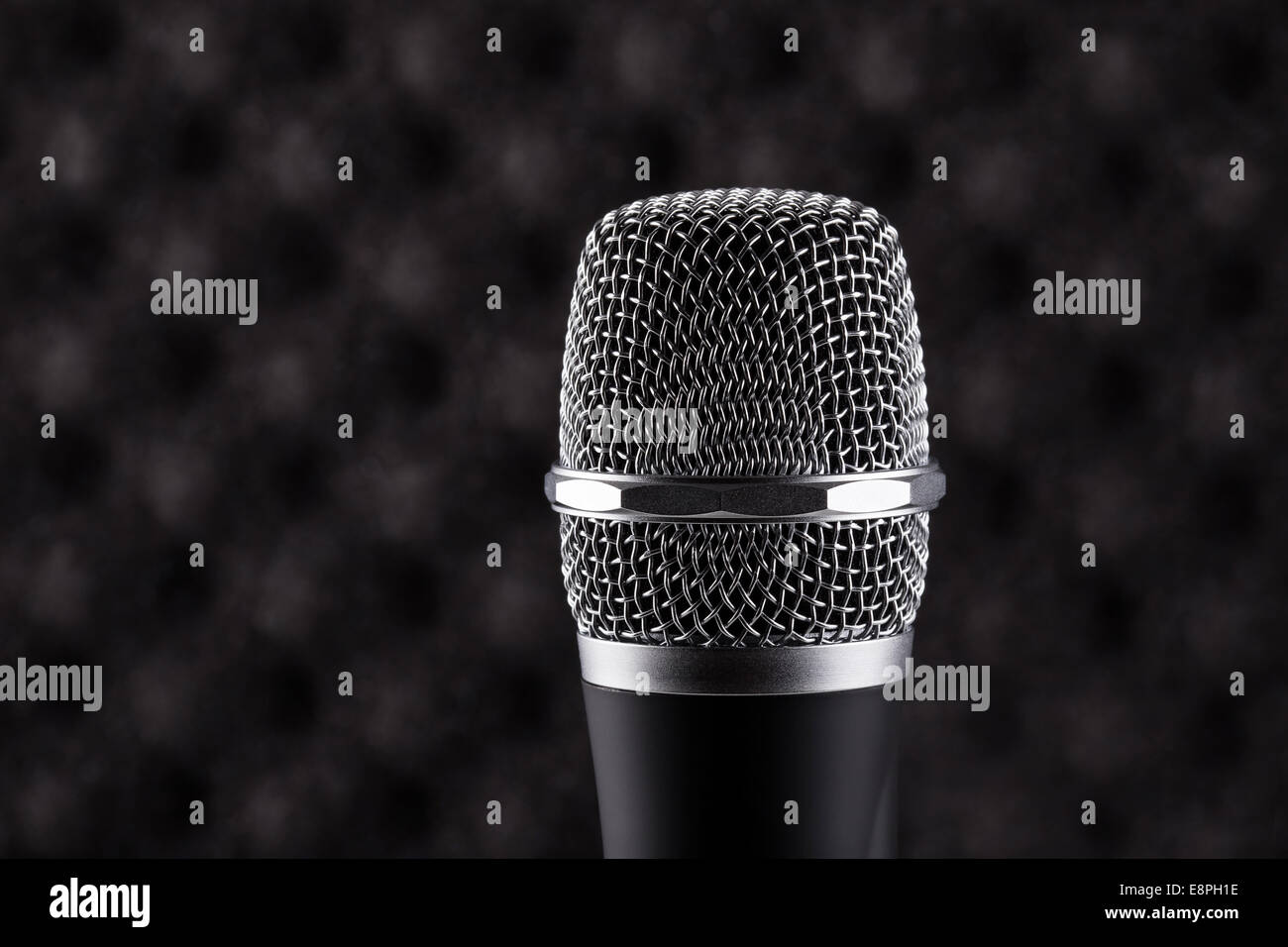 Wireless microphone closeup on foam rubber acoustic treatment ...