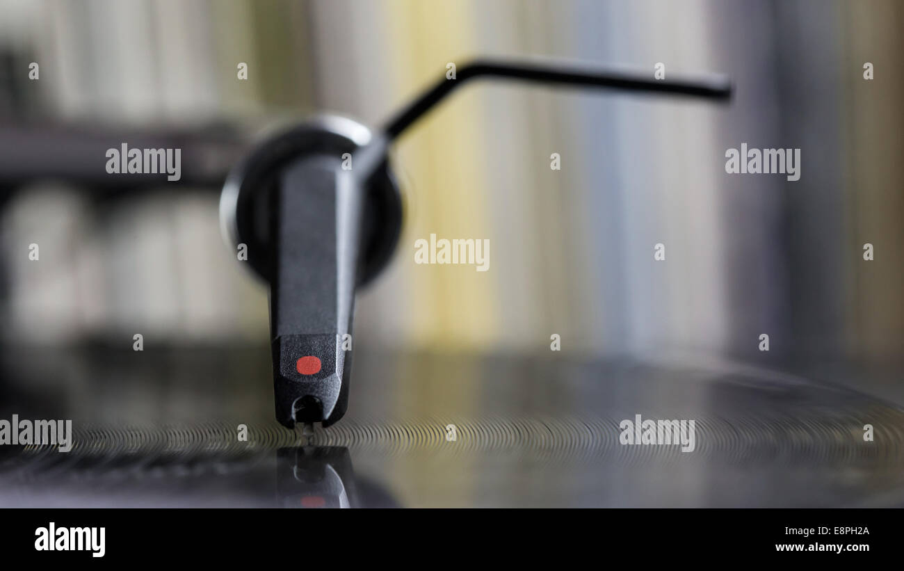 Dj needle stylus on spinning record, vinyl background Stock Photo - Alamy