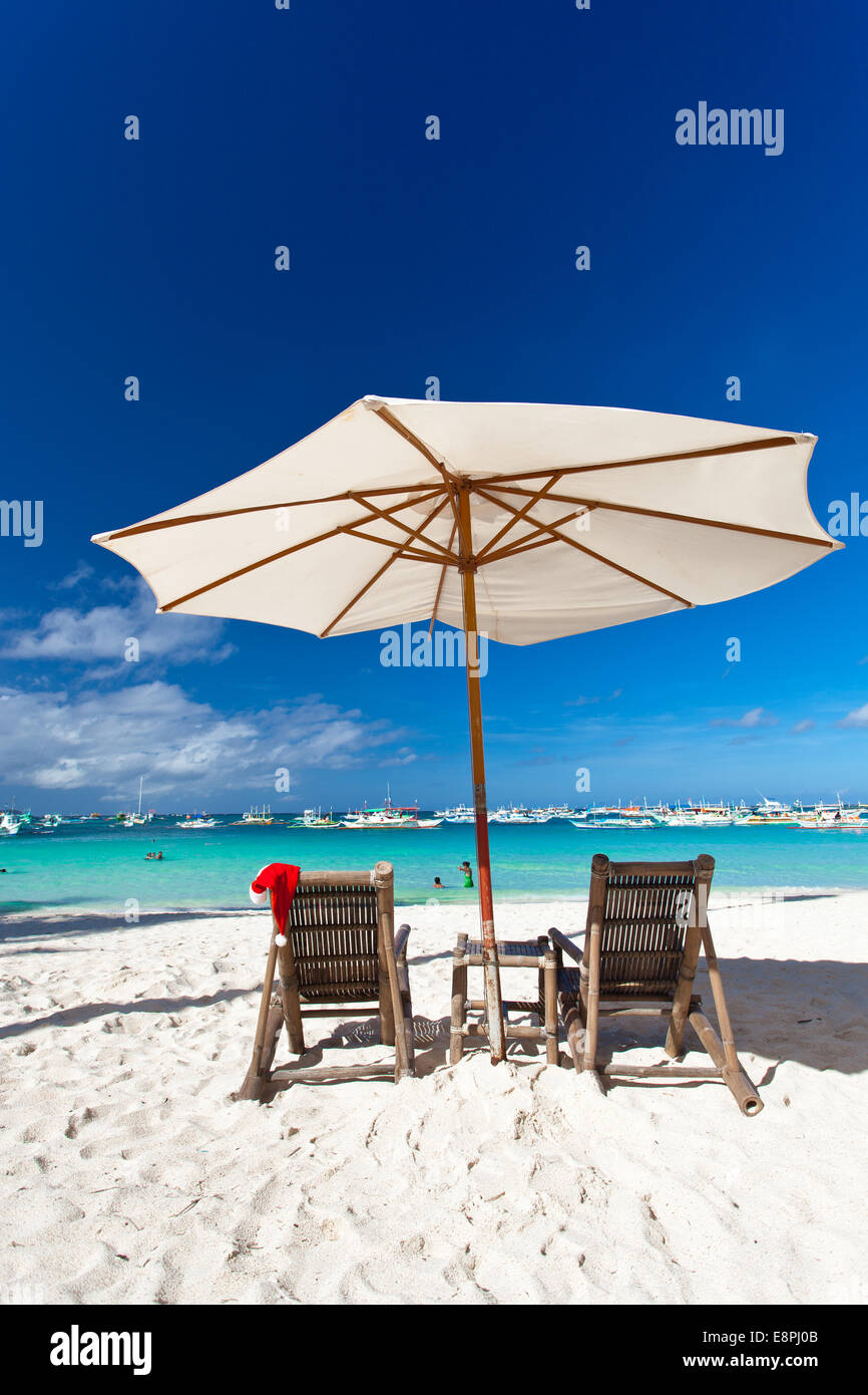Sun umbrella with Santa Claus Hat on chairs on tropical beach Stock ...